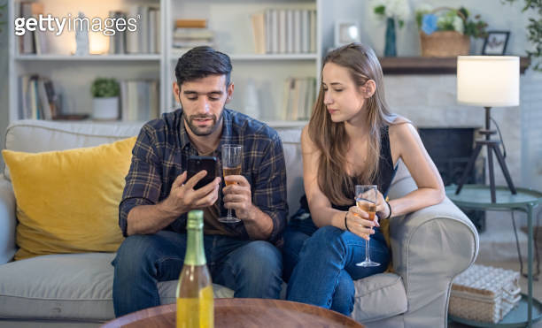 Diverse startup colleagues enjoy drinks, socializing in a relaxed ...