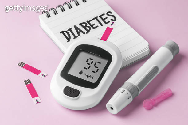 Glucometer, blood glucose sugar testing, diabetes concept on pink ...