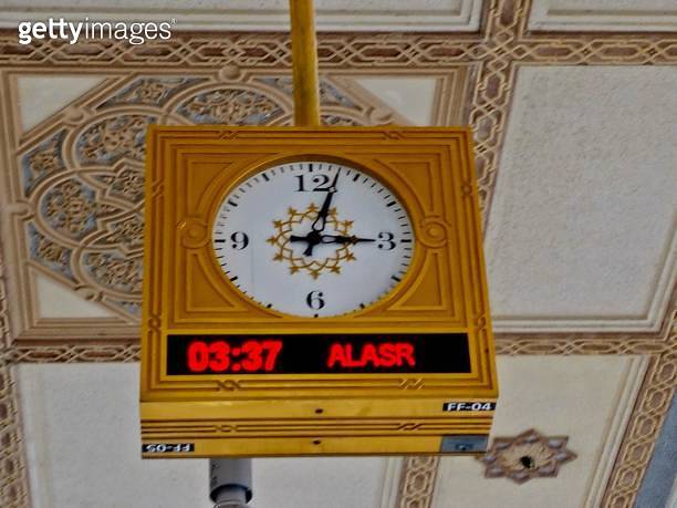 A clock in Al Masjid al-Haram, the Sacred Mosque or the Great Mosque of ...