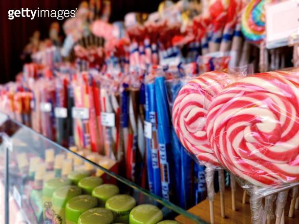 Detailed shot of red white round lollipops that are lined up in a row ...