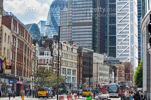 City of London Bishop's gate road with skyscrapers, old buildings and ...