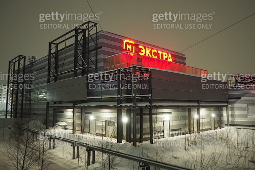 Magnit Extra hypermarket building on Pravdy Street, exterior. Blizzard ...