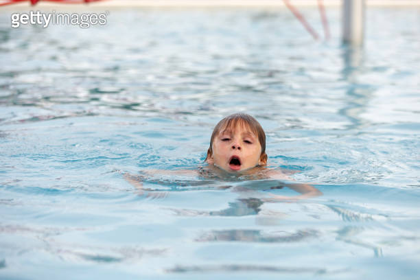 Hands of drowning person stretching out of the water in swimming pool ...