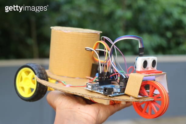 Prototype of floor cleaning robot made with simple materials held in ...