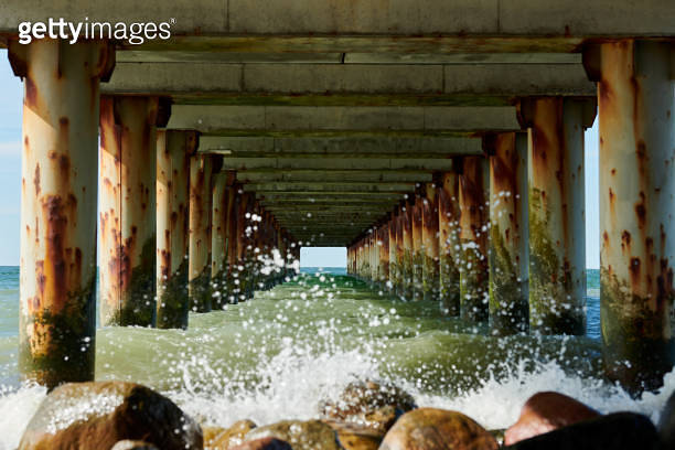 Rusty pillars of old sea pier create mesmerizing seascape scene with ...