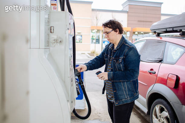 Adult Caucasian Man At Gas Pump Fueling his Car 이미지 (1894056378) - 게티이미지뱅크