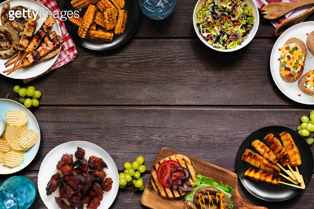 Summer BBQ or picnic food frame, top down view on a dark wood ...