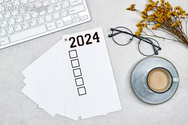 New year goals 2024 on desk. 2024 goals list with notebook, coffee cup ...