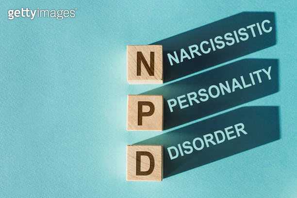 Three signs prominently display the words narcissistic, personality ...