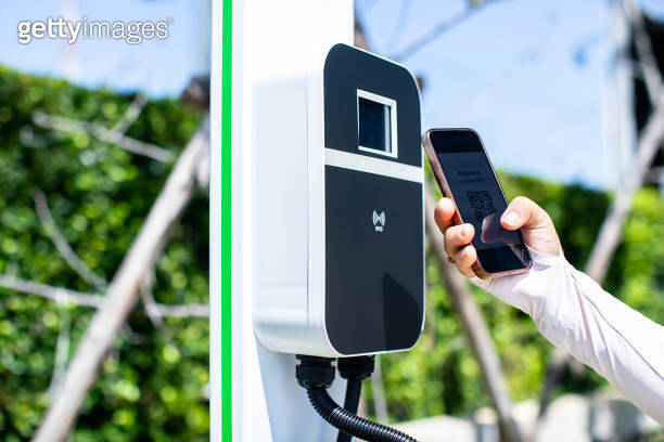 EV Driver use smartphone to scan QR Code on electric vehicle charging ...