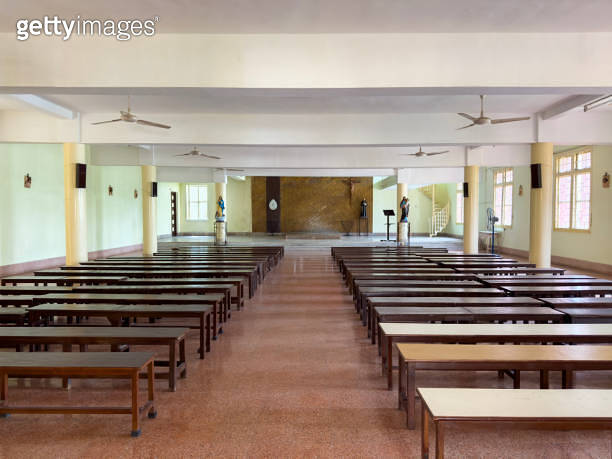 Interior view of a modern church with empty benches, chairs, pews ...