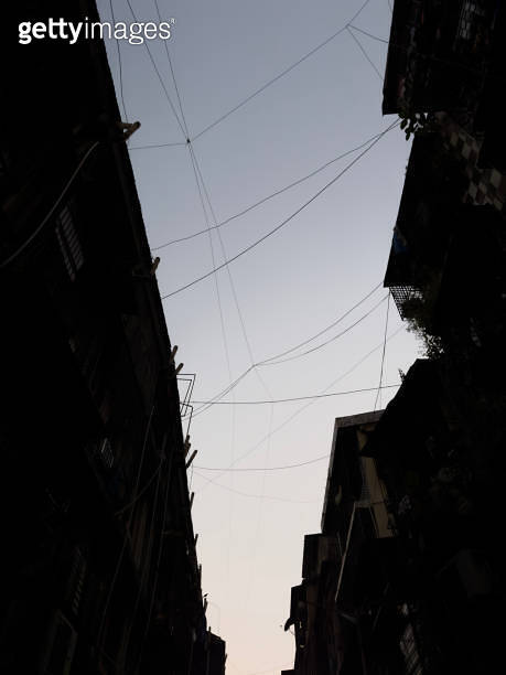 Upside evening clean sky view from the two old buildings and wires ...