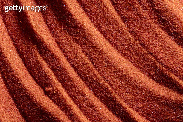 Small bright orange crystals of potassium dichromate, closeup, abstract ...