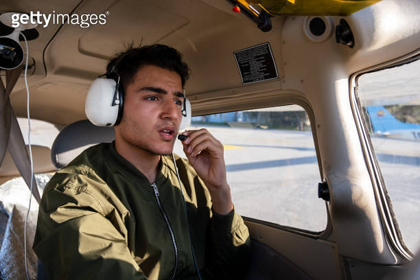 Young pilot candidate receiving flight training meets with the tower ...