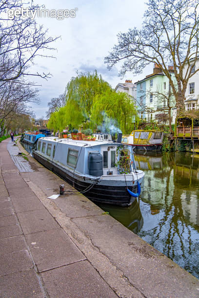 Woman running along the Regent's Canal promenade in London's Little ...