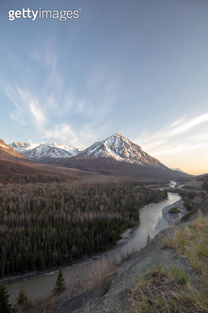 Evening blue sky over Matanuska River flowing past Chugach Mountains ...