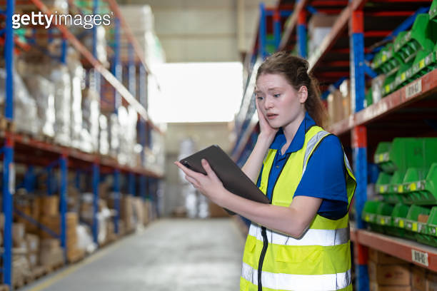 Woman warehouse worker feeling confused and failed to check inventory ...