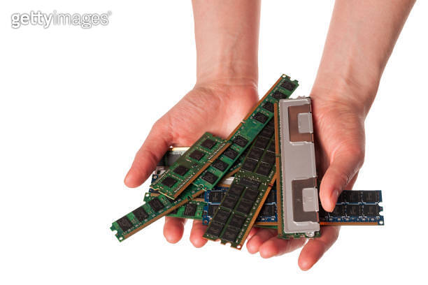 Hand holding RAM modules to assemble a computer, choosing the right ...