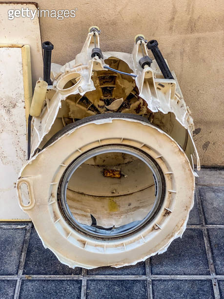 Part of broken washing machine abandoned in the street (2155383067 ...