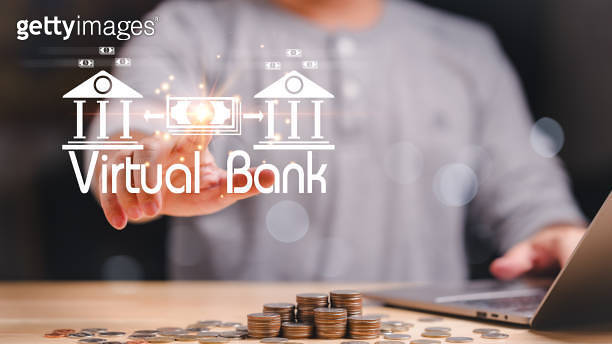 man is pointing at a computer screen with the words "virtual bank" on ...