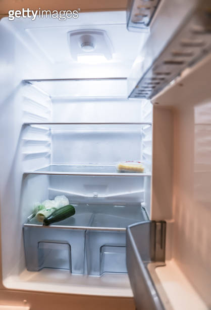 Almost empty refrigerator with open door (2000088347) - 게티이미지뱅크