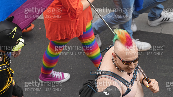 Gay fetishist walk lgbt pride. Puppy team member with rainbow mohawk ...