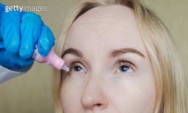 Examination of the fundus and dilated pupils. A doctor performs an ...