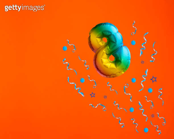 Confetti explosion with number 8 balloon - Celebration on orange ...