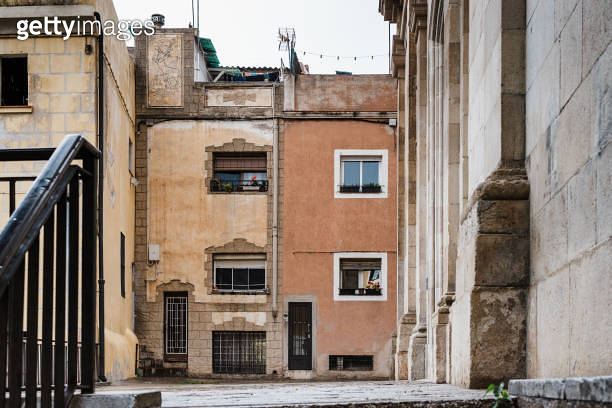 Narrow view between old buildings showcasing architectural textures and ...