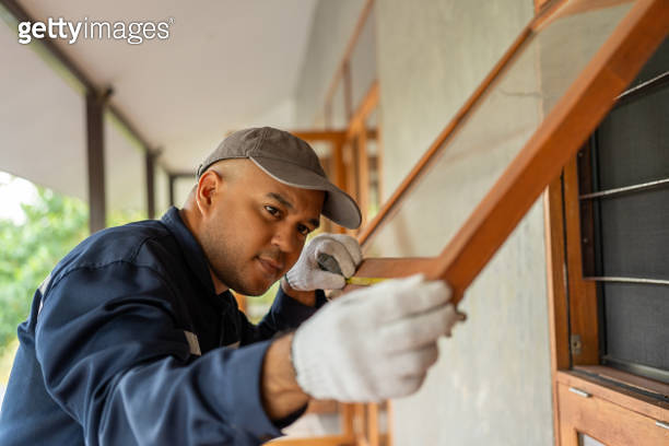 Technician worker in uniform using measuring tape tool to measuring ...