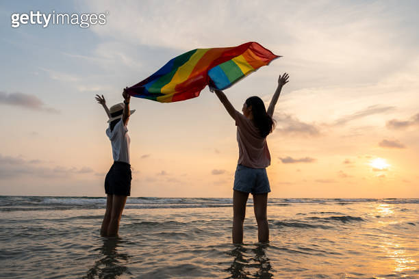 Young couple asian lesbian with pride movement LGBT holding rainbow ...