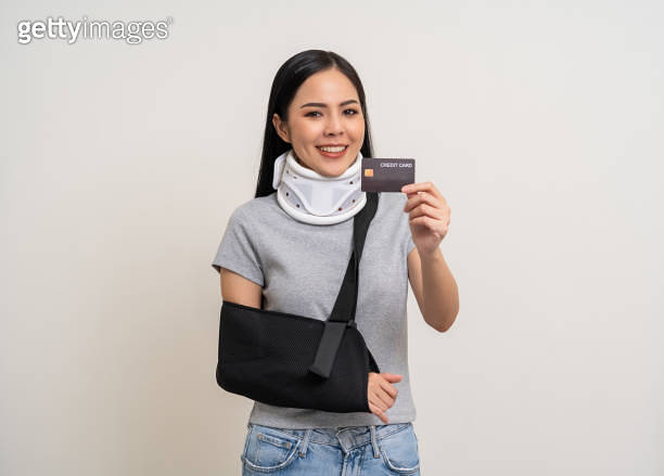 Asian woman broken arm and leg holding credit card payment. Woman put ...