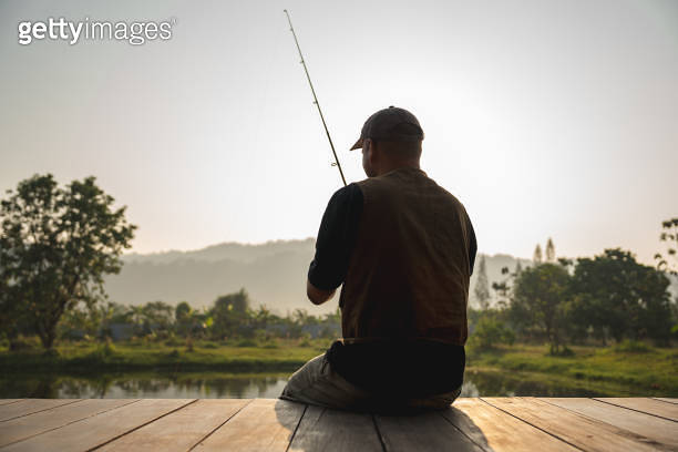 Excited emotion of Handsome fisherman fishing as a leisure activity ...