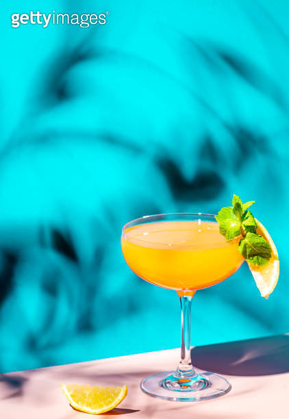 Yellow alcoholic cocktail drink with rum, liquor, grapefruit and lemon ...