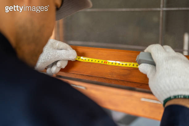 Technician worker in uniform using measuring tape tool to measuring ...