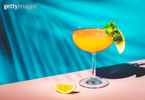 Yellow alcoholic cocktail drink with rum, liquor, grapefruit and lemon ...