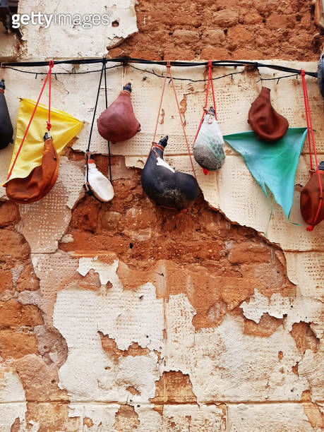 Hanging Wineskins. Closeup of series of handmade curved wineskin of ...