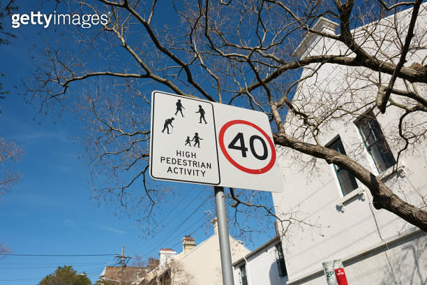 Speed limit and high pedestrian activity zone sign on a pole ...