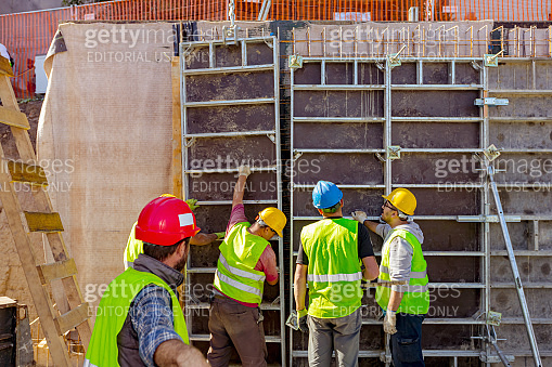 Boss oversees, control riggers, workers as assembly wooden demountable ...