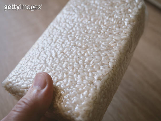 Male hands holds. package of rice for preparing risotto. Vacuum packed ...