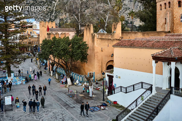 Place Outa El Hamam square with group of people at sunset in ...