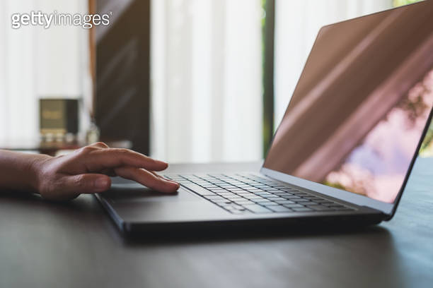 Closeup image of a woman hand working and touching on laptop computer ...