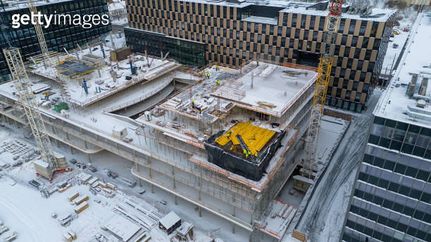 Drone photography of constructions site surrounded by buildings in a ...