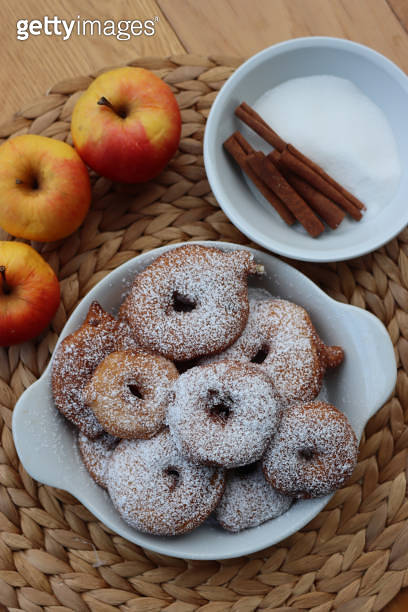 Deep fried apple rings with batter sprinkled with powdered sugar on ...