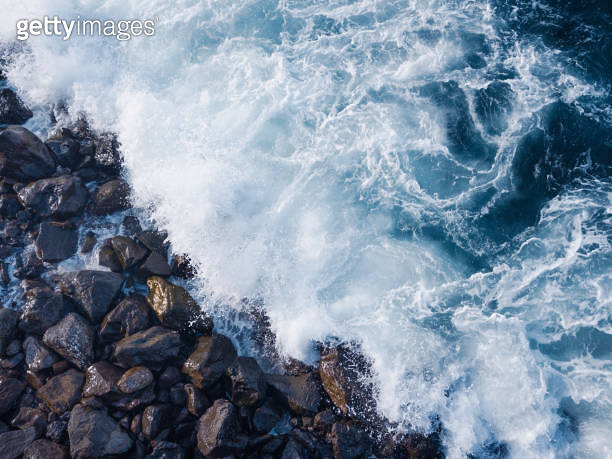 Rocky beach with Atlantic Ocean waves meeting with underwater sharp ...