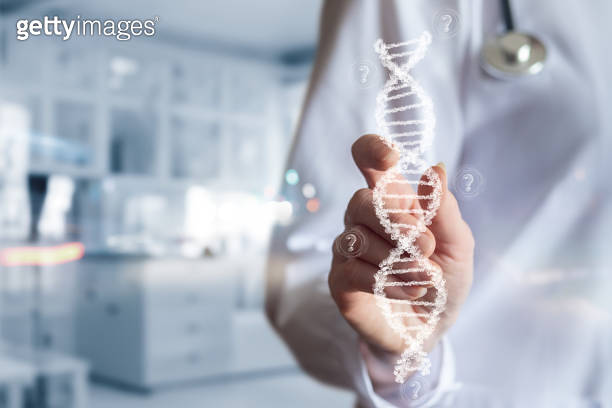 Laboratory assistant shows DNA molecule with question marks ...