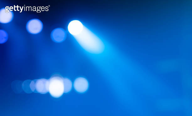Blurred spotlights or light beams on-stage performance, concert ...