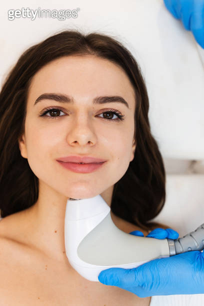 Face-lifting with help of special cosmetology device. Needle-free rf ...