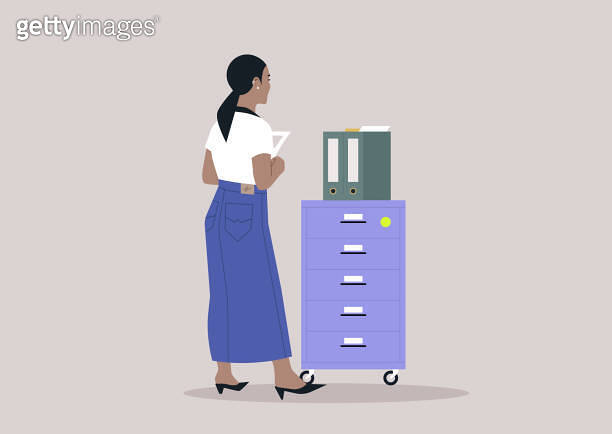 Employee Organizing Files in a Modern Office Setting, A person stands ...