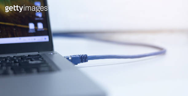 close up on blue RJ-45 Lan cable connect to computer port or laptop to ...